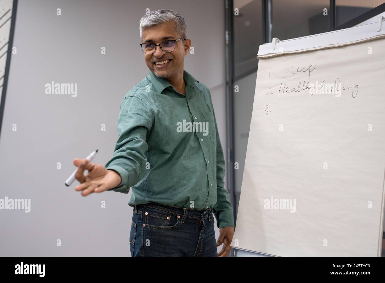Businessman writing ideas on flip chart Stock Photo - Alamy