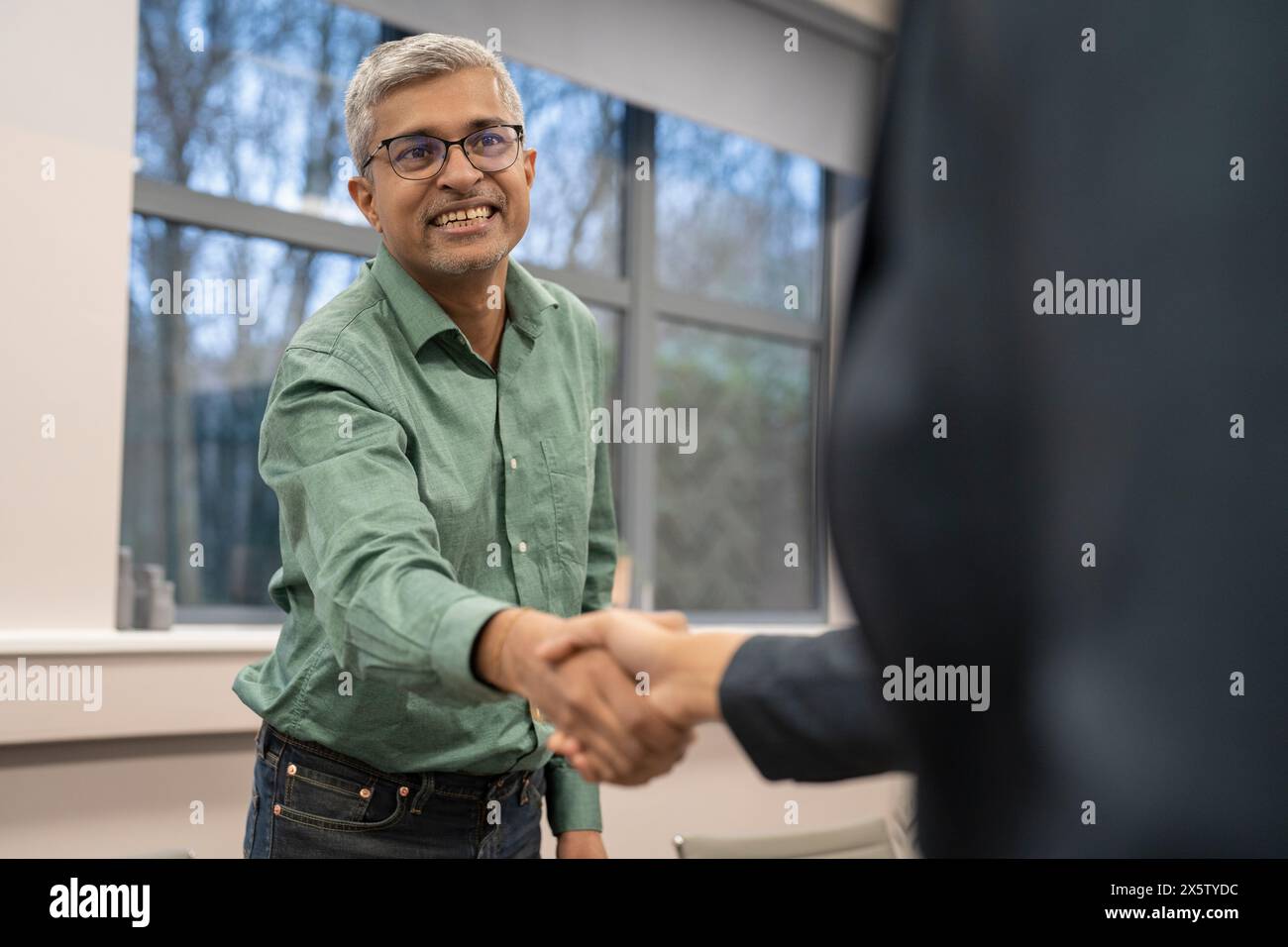 Business people shaking hands during meeting Stock Photo - Alamy