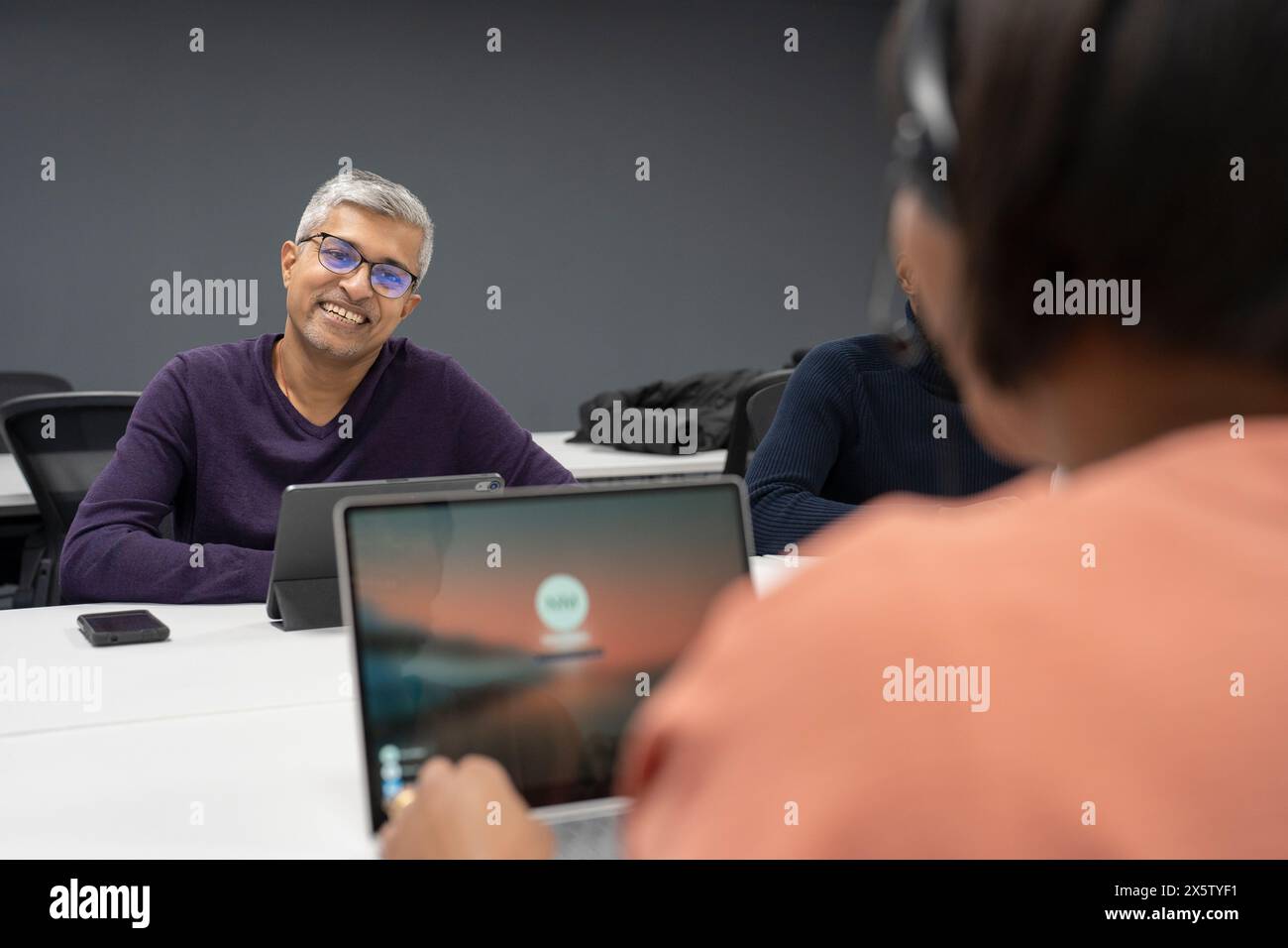 Business people working on laptops in office Stock Photo - Alamy