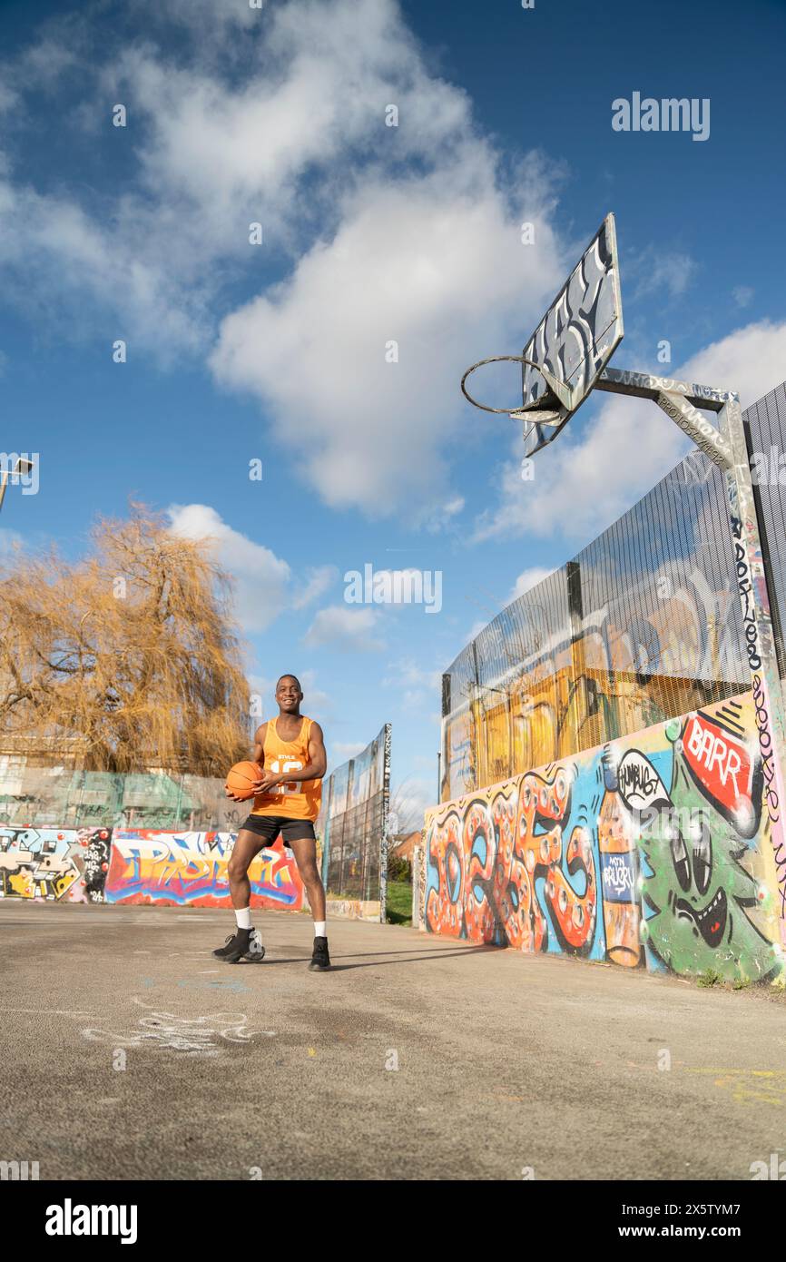Man playing basketball outdoors Stock Photo - Alamy