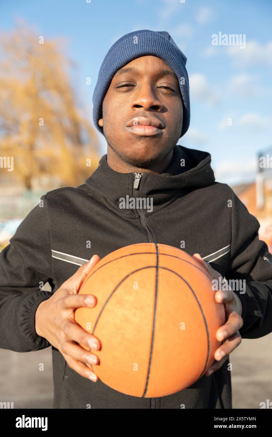 Portrait of man with basketball ball outdoors Stock Photo - Alamy
