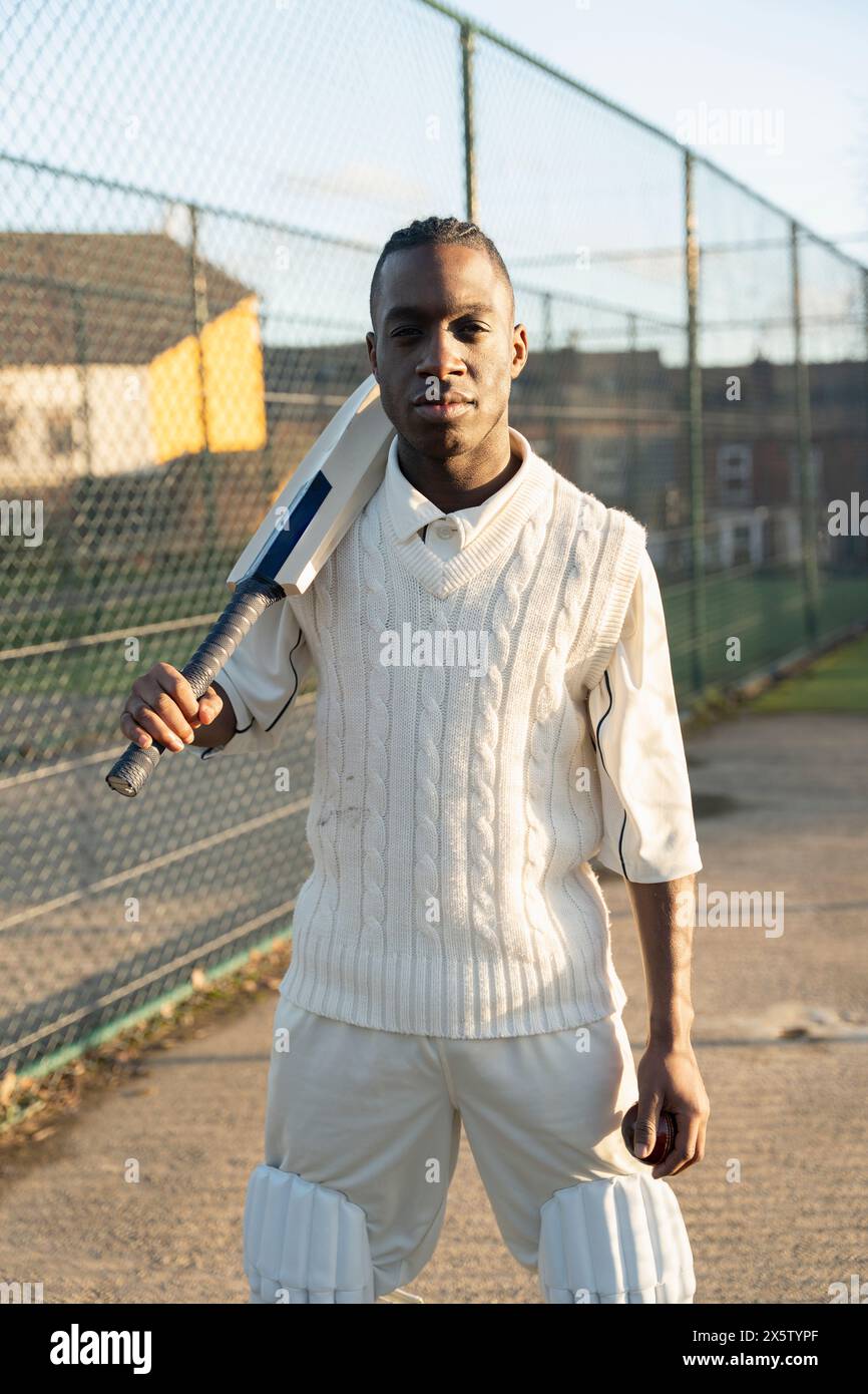 Portrait of cricketer standing on outdoors sports court Stock Photo - Alamy