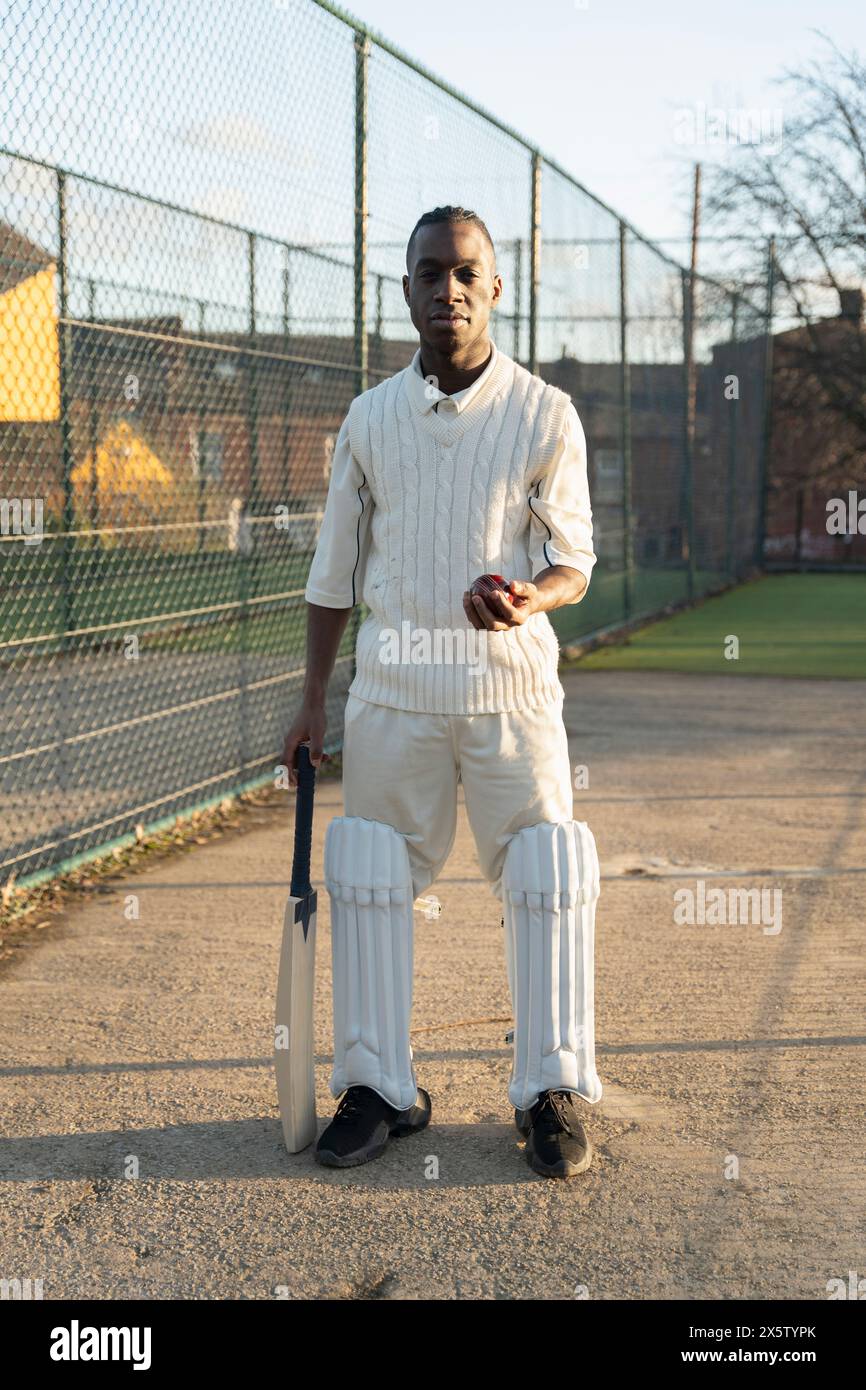 Portrait of cricketer standing on outdoors sports court Stock Photo - Alamy