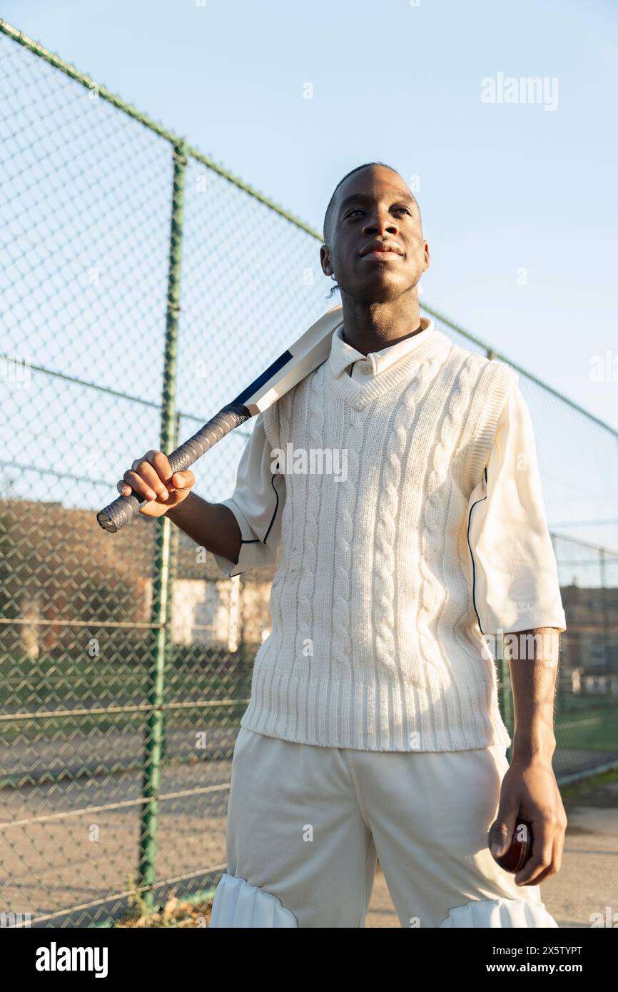 Portrait cricket player holding bat hi-res stock photography and images ...