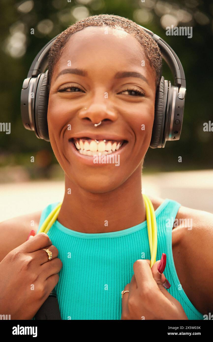 Portrait of smiling athlete woman with headphones Stock Photo - Alamy