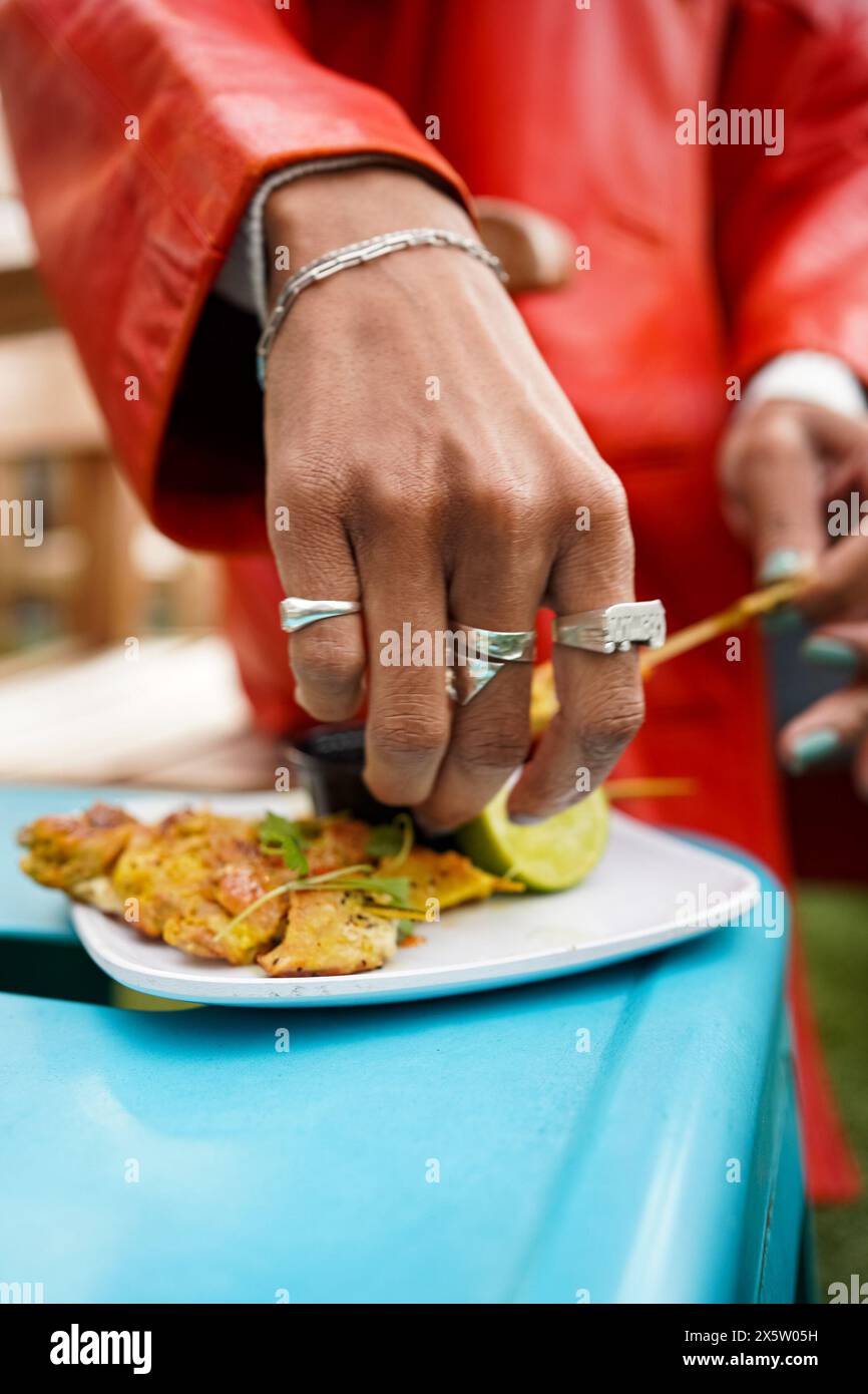 Close-up of hand of woman eating snack Stock Photo - Alamy