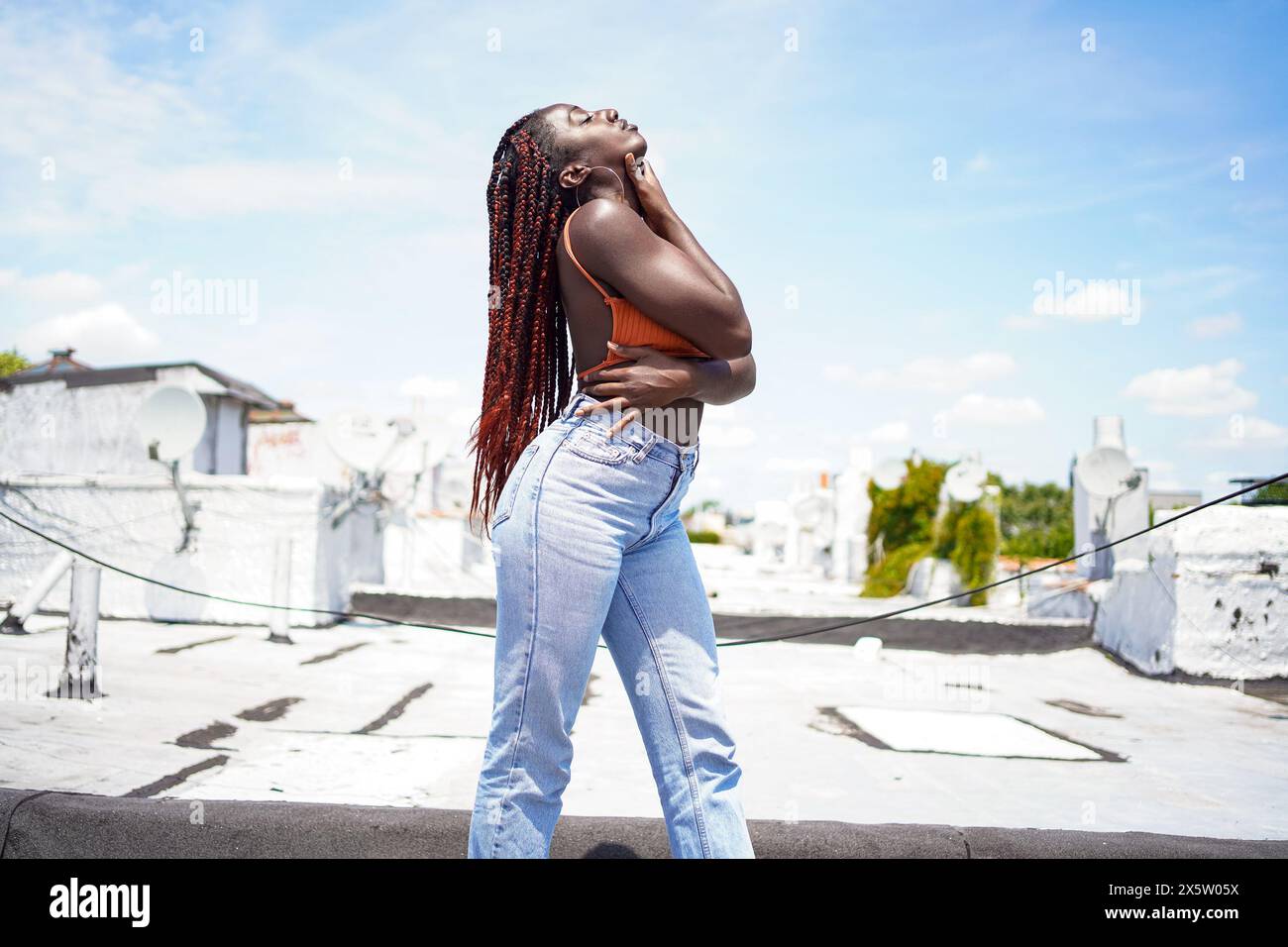 Stylish woman on rooftop Stock Photo - Alamy