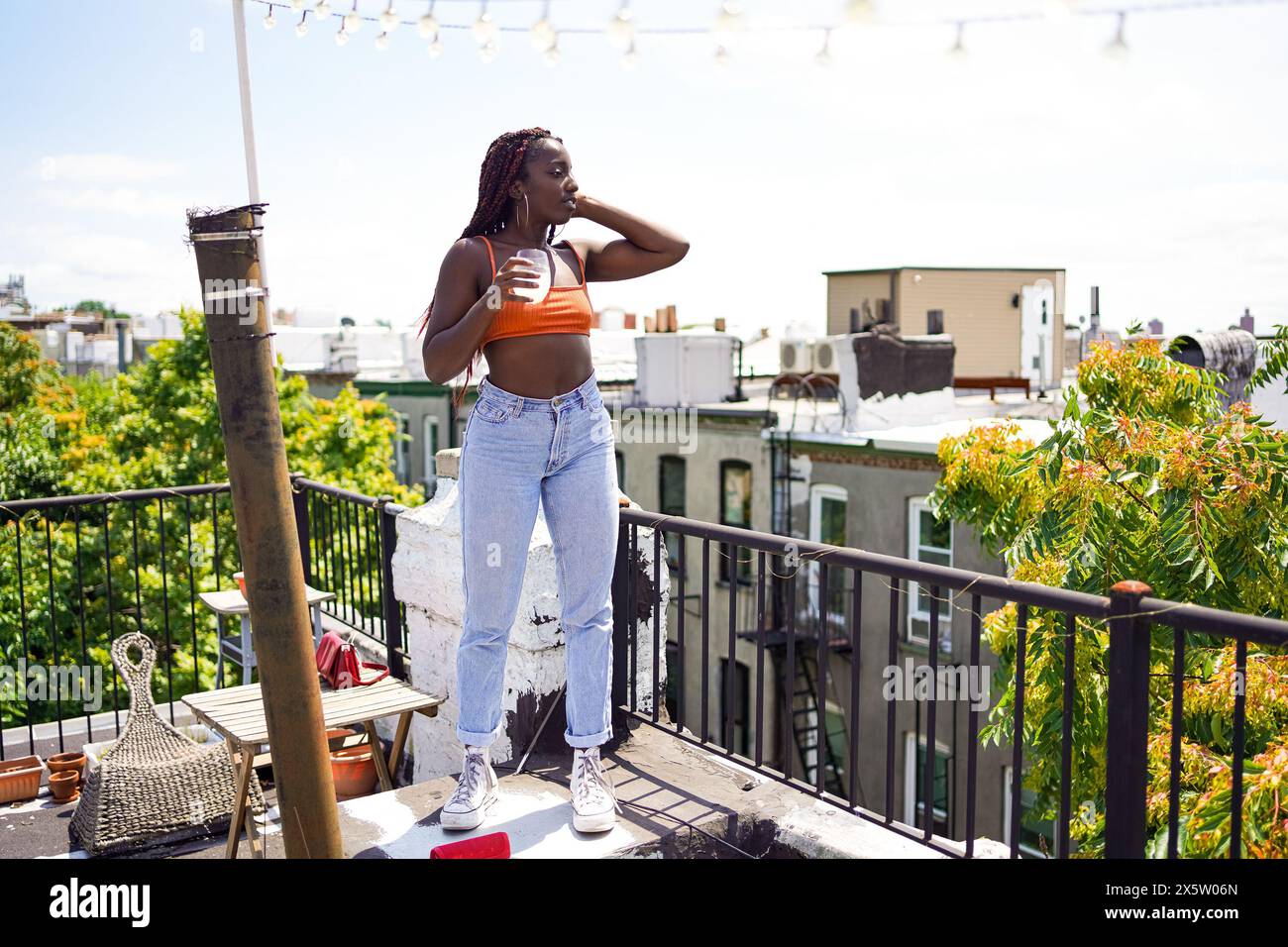 Woman braids on terrace hi-res stock photography and images - Alamy