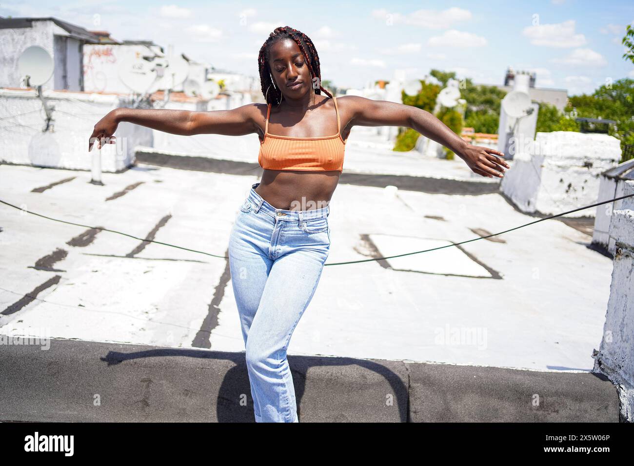 Woman with dancing on rooftop Stock Photo - Alamy