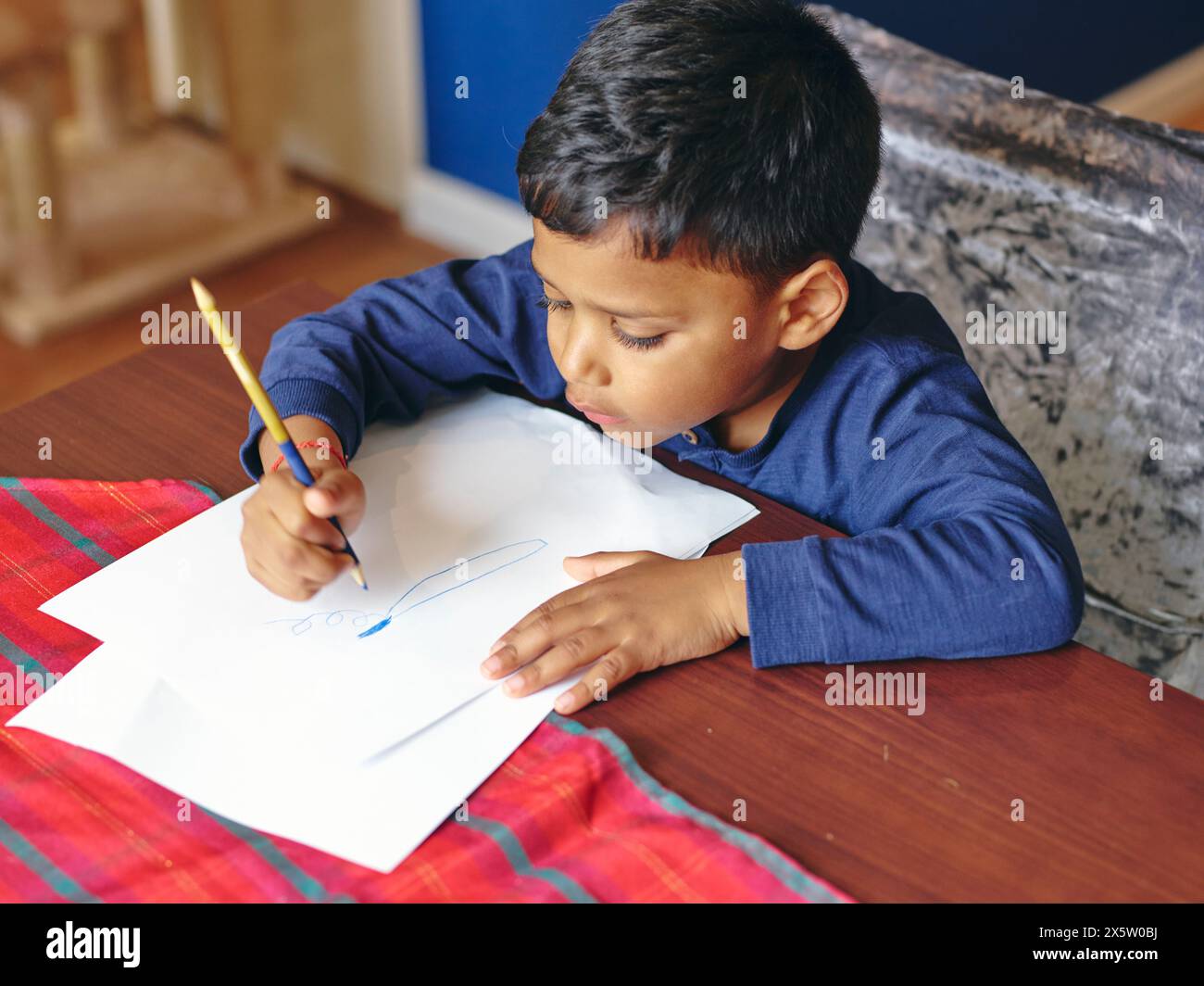 Boy drawing on paper Stock Photo - Alamy