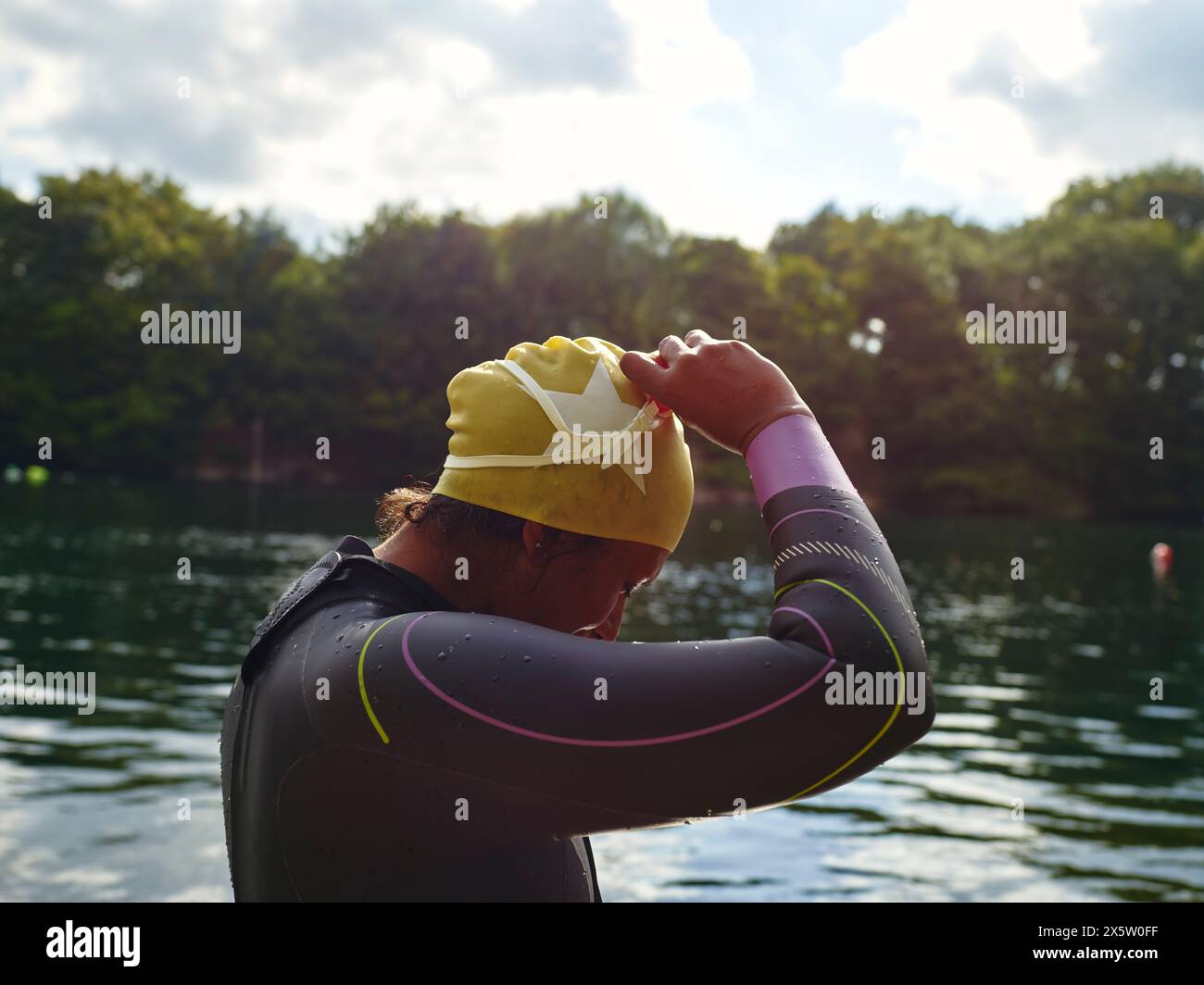 Woman taking off swimming goggles Stock Photo - Alamy