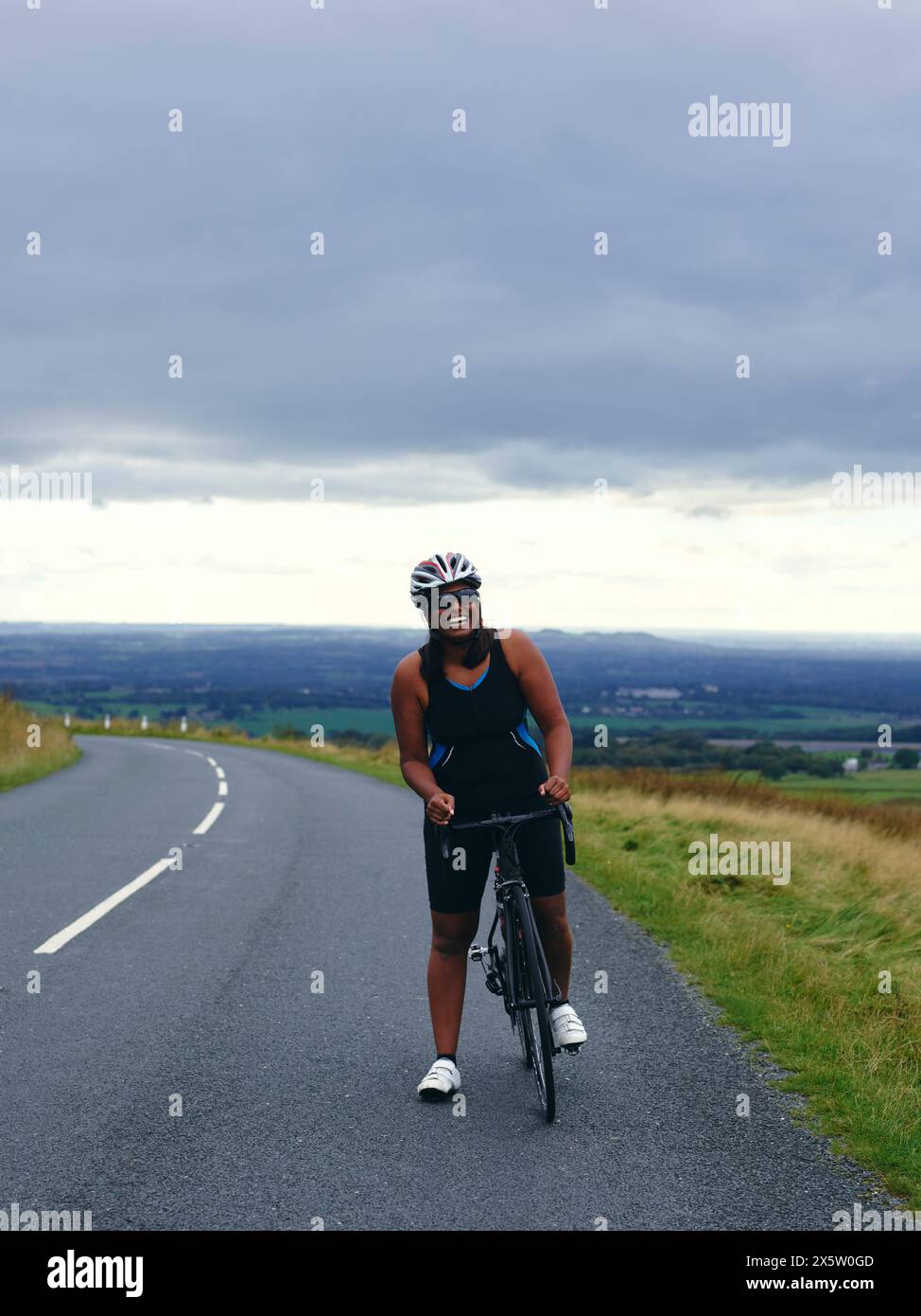Smiling female cyclist hi-res stock photography and images - Alamy