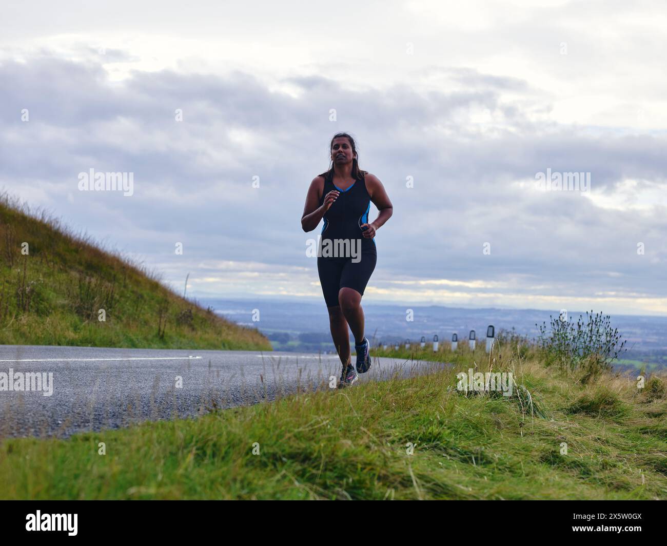 Female runner on road hi-res stock photography and images - Alamy