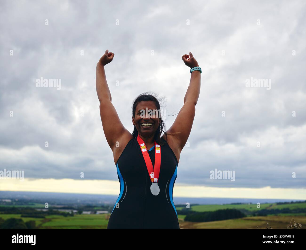 Female athlete celebrating winning medal Stock Photo - Alamy