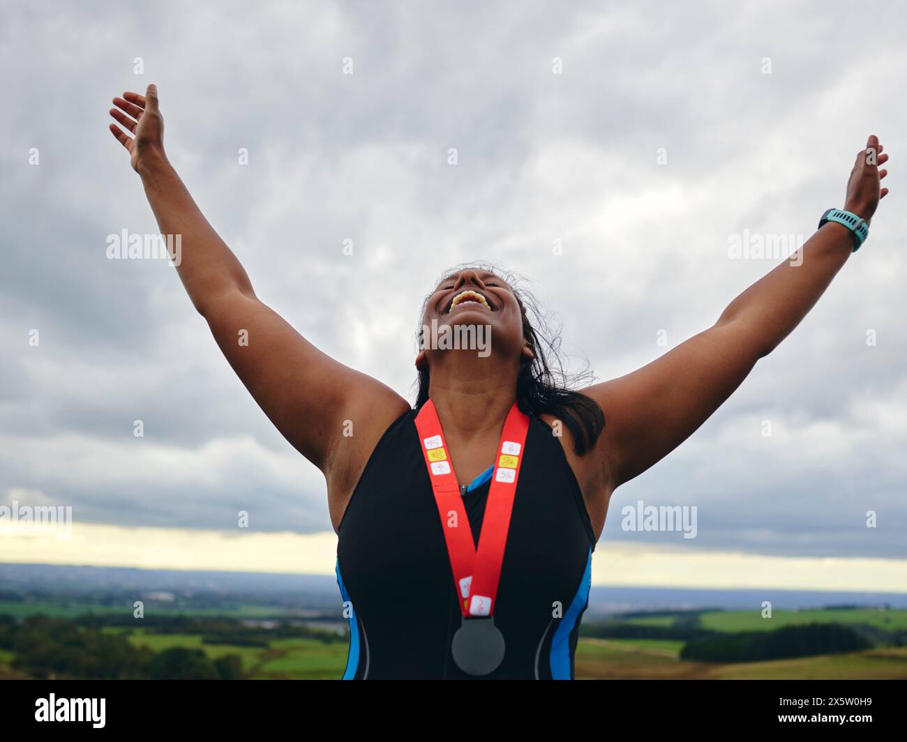 Female athlete celebrating winning medal Stock Photo - Alamy