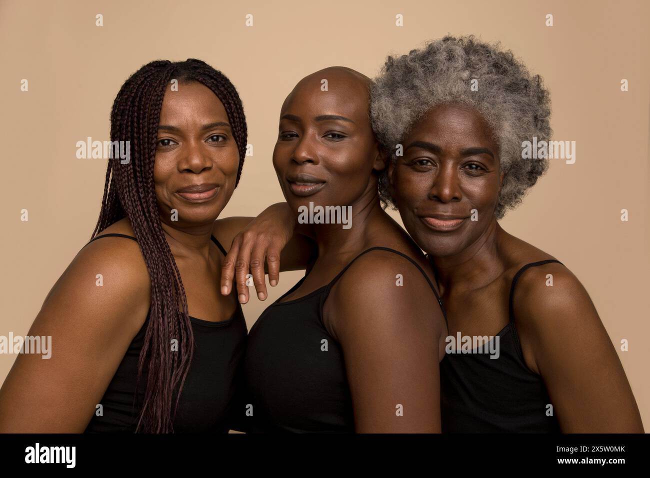 Studio portrait of three smiling women in black tops Stock Photo - Alamy