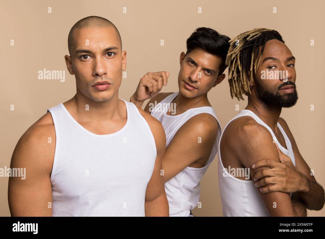 Studio portrait of men in white tank tops Stock Photo - Alamy