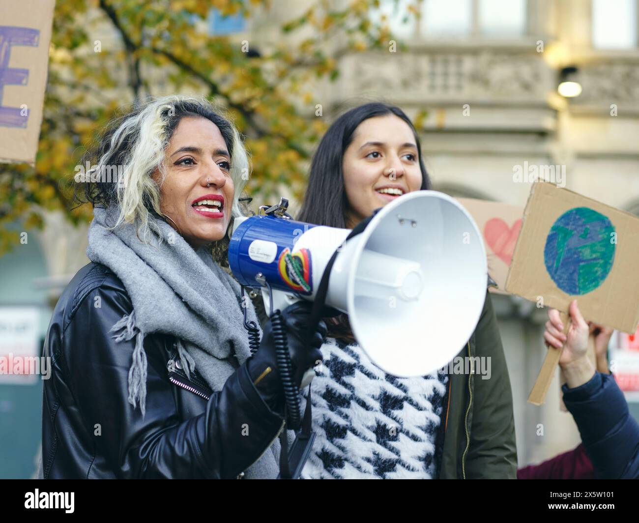 Activists holding peace signs protesting in street Stock Photo - Alamy