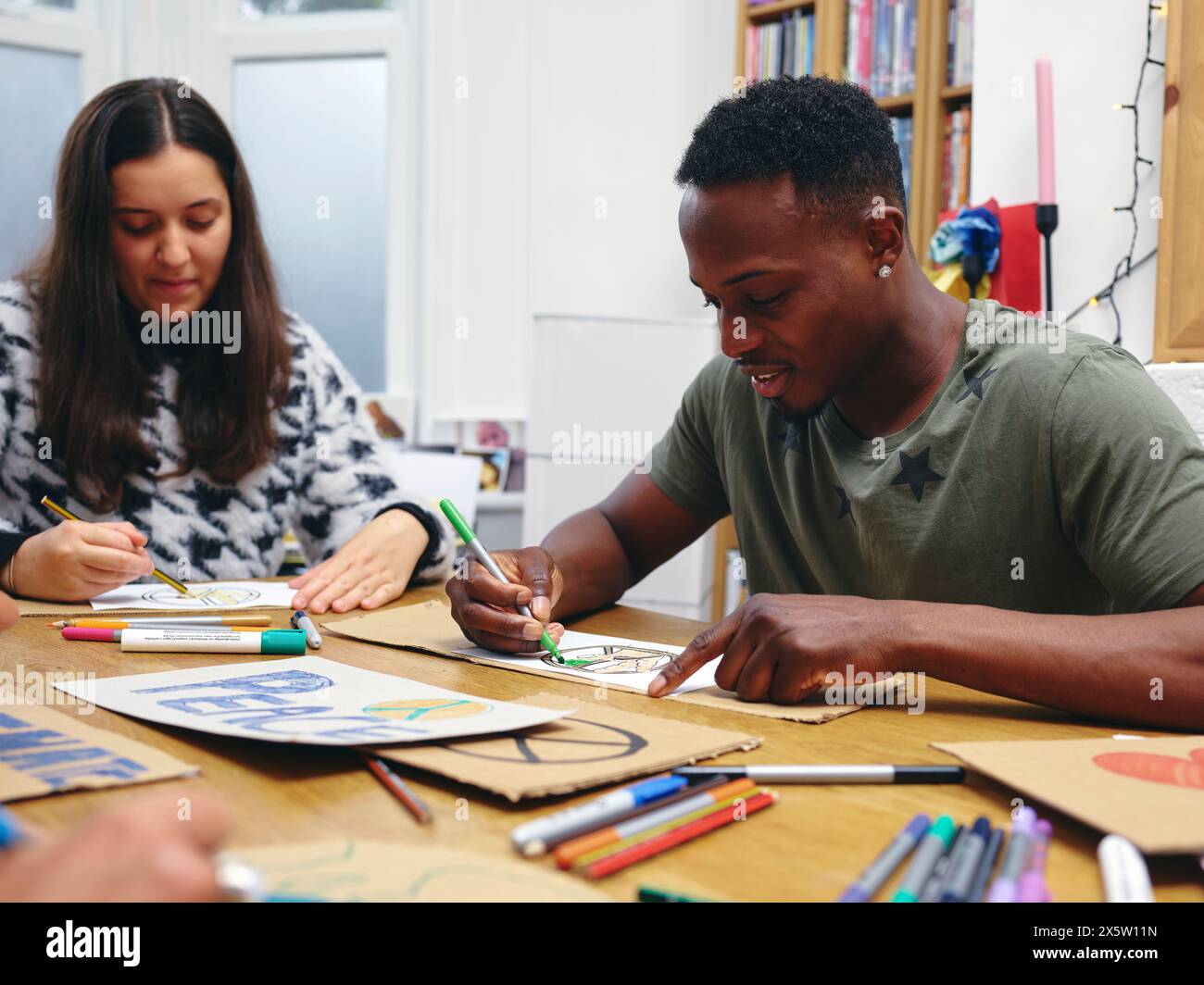 People sitting in room and making protest signs Stock Photo - Alamy