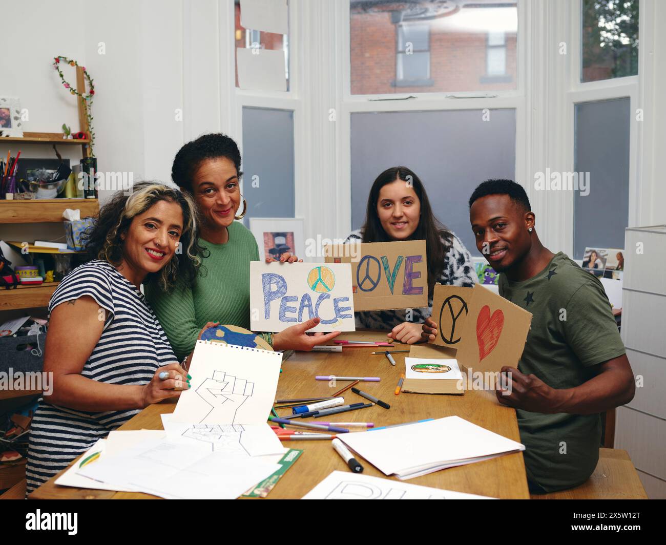 People making protest signs with symbols of peace Stock Photo - Alamy