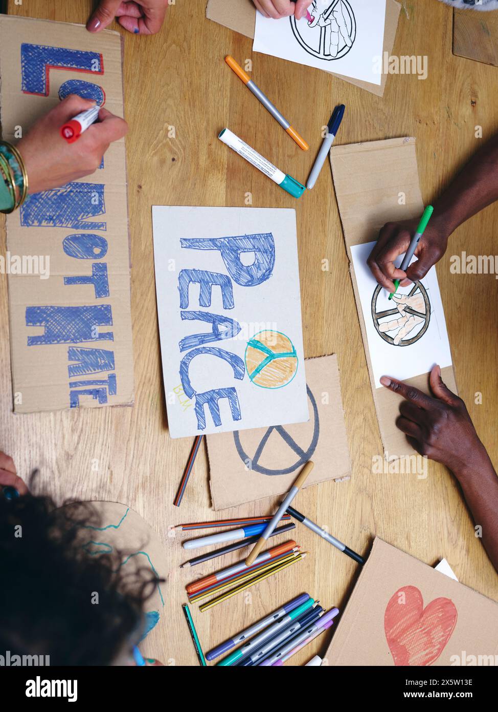 People making protest signs with symbols of peace Stock Photo - Alamy