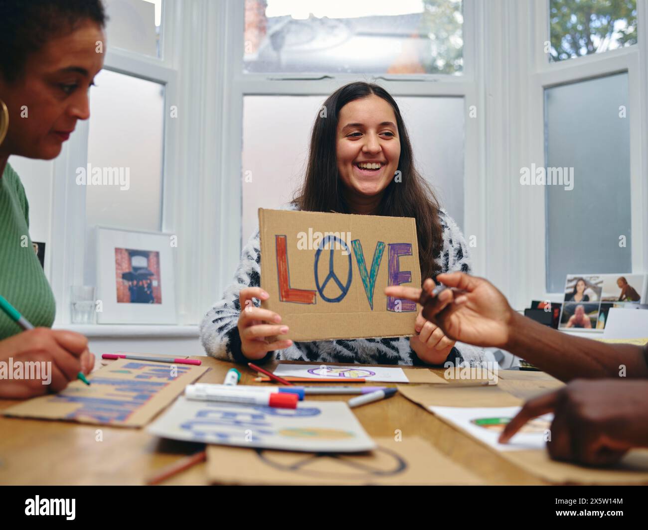People making protest signs with symbols of peace Stock Photo - Alamy