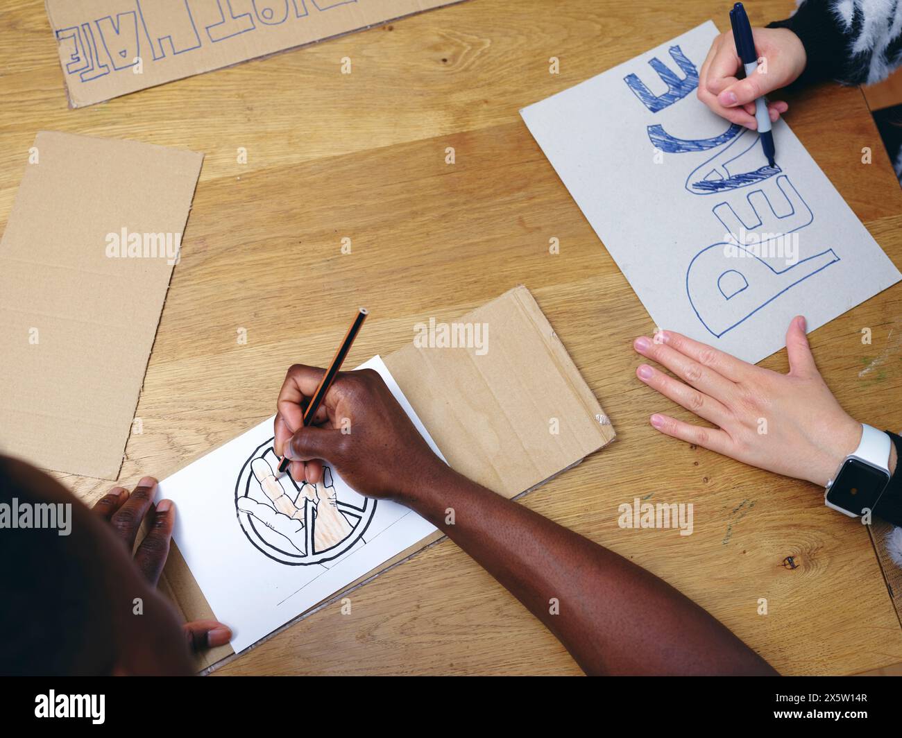 People making protest signs with symbols of peace Stock Photo - Alamy