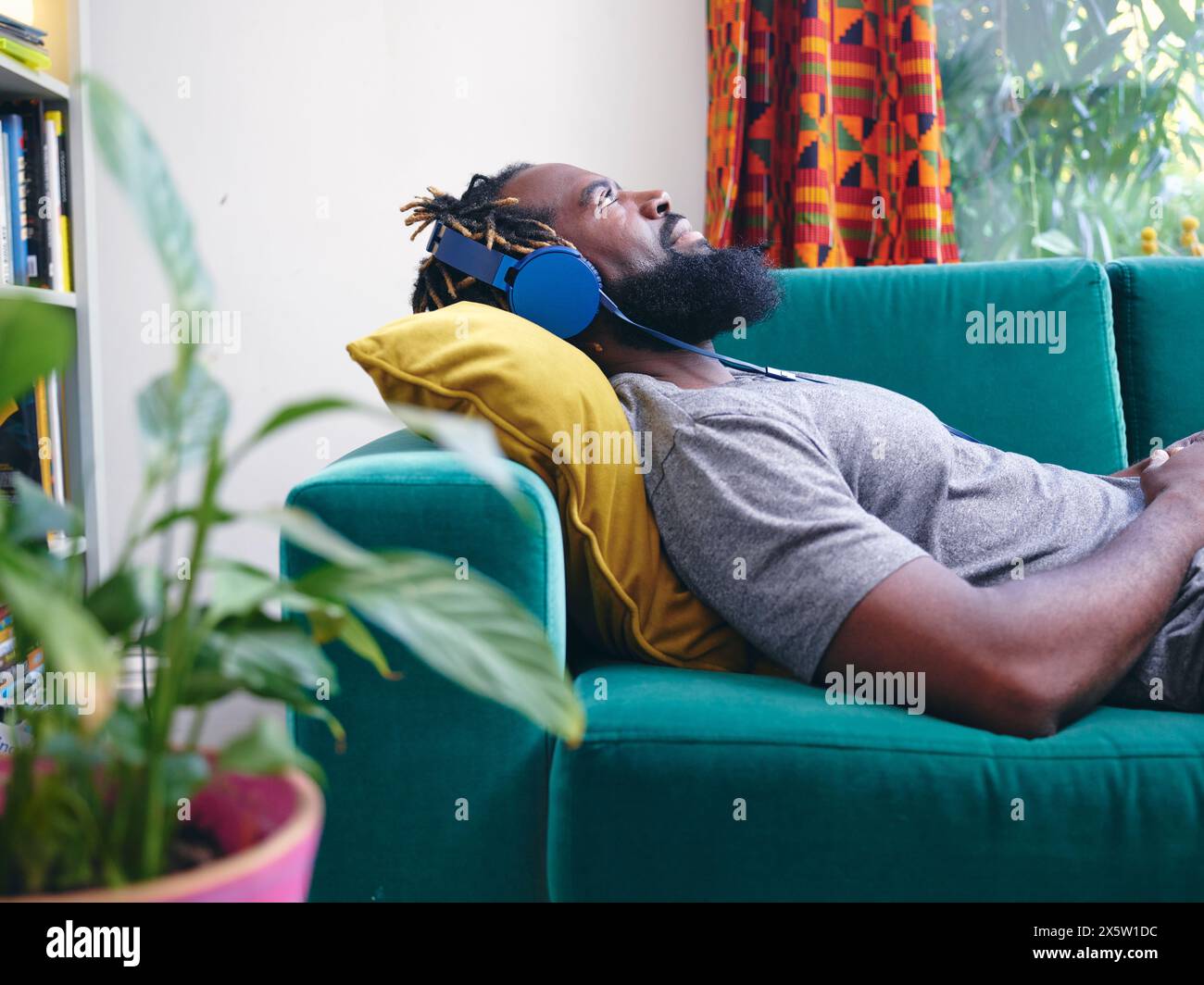 Man listening music lying on hi-res stock photography and images - Alamy