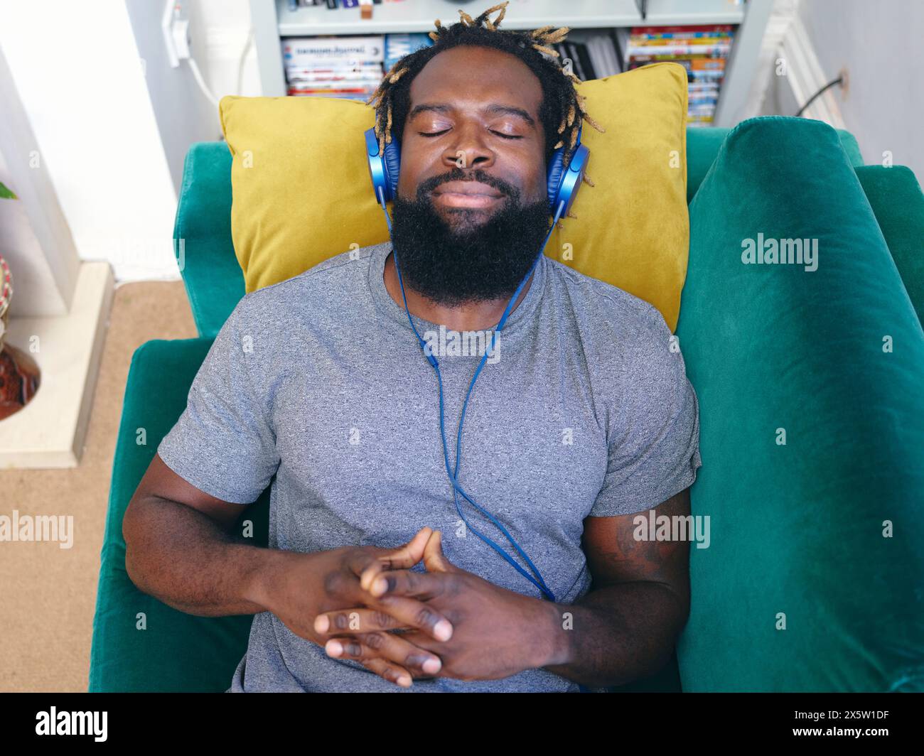 Man listening music lying on hi-res stock photography and images - Alamy