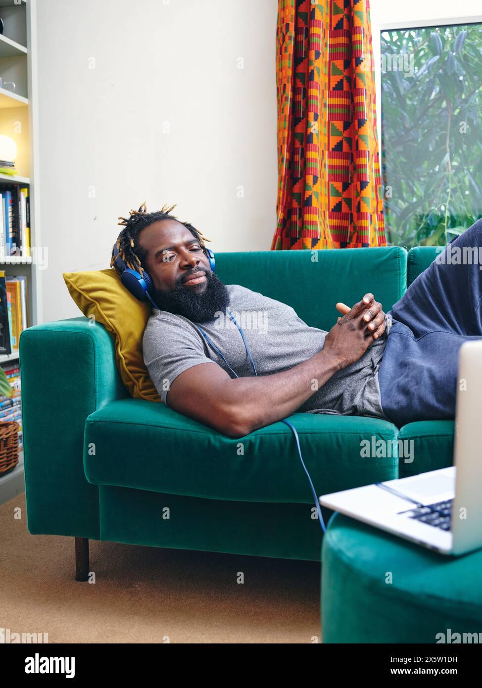 Man listening music lying on hi-res stock photography and images - Alamy