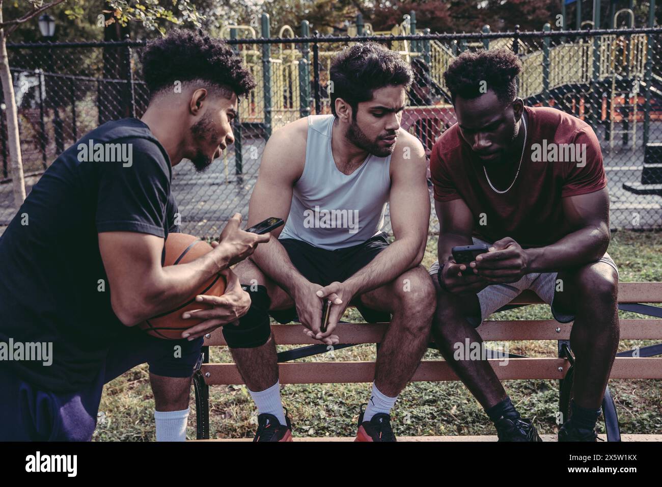 USA, Pennsylvania, Philadelphia, Three male friends sitting at ... USA, Pennsylvania, Philadelphia, Three male friends sitting at ...