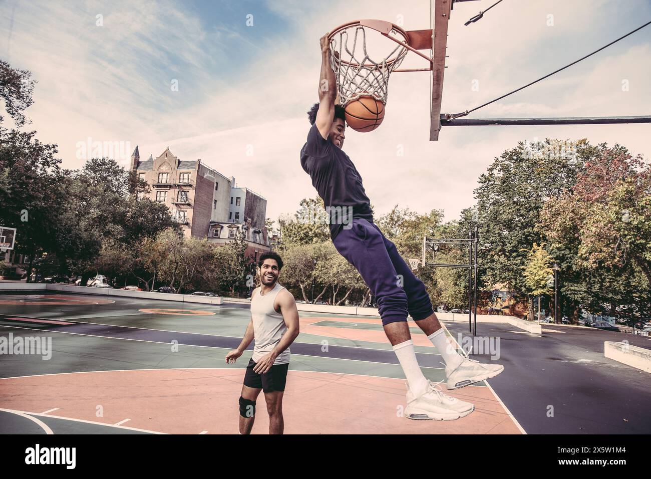 USA, Pennsylvania, Philadelphia, Men playing basketball in park Stock ...