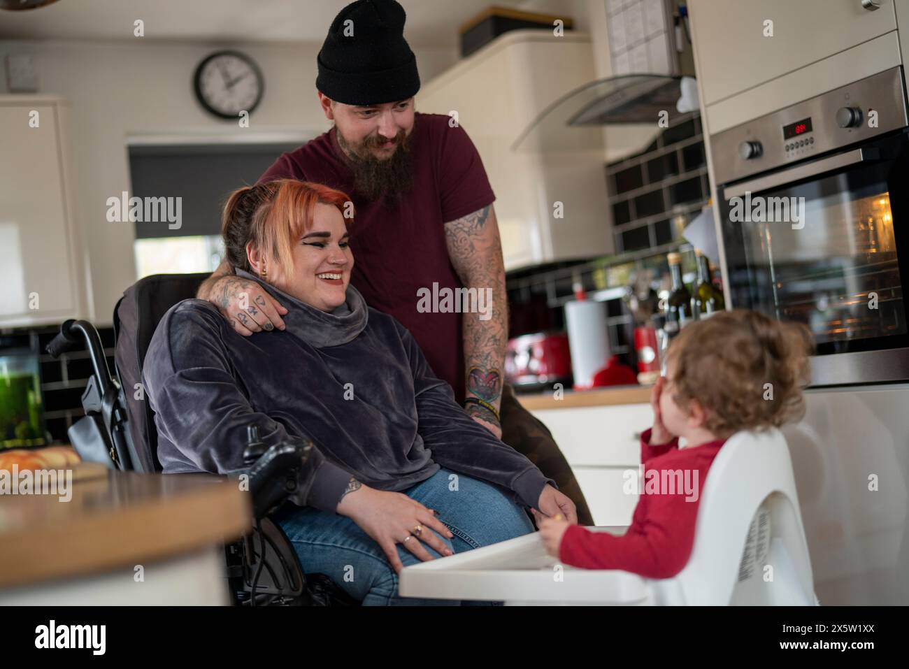 Parents with baby son in high chair Stock Photo - Alamy