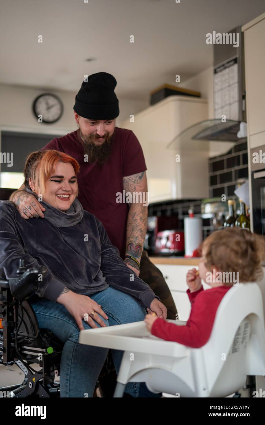 Parents with baby son in high chair Stock Photo - Alamy