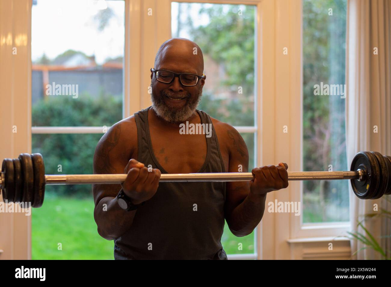 Senior man lifting barbell Stock Photo - Alamy