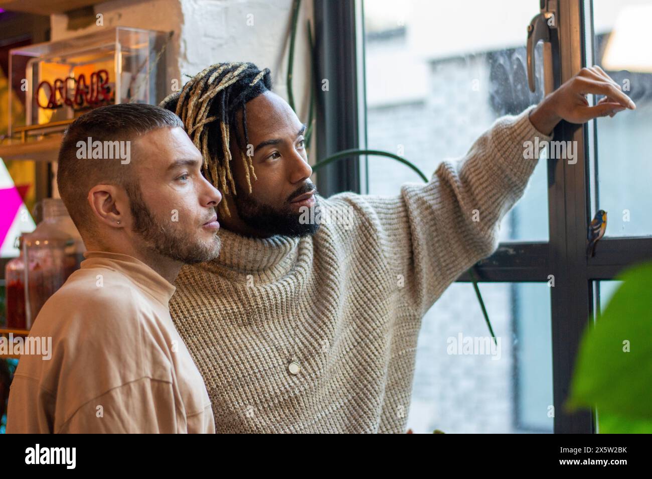 Men looking through window Stock Photo - Alamy