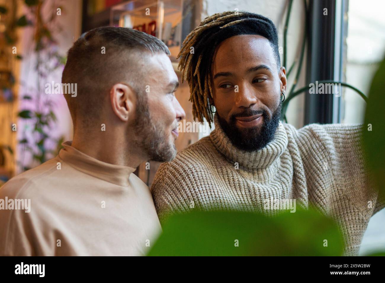 Two men looking at each other Stock Photo - Alamy