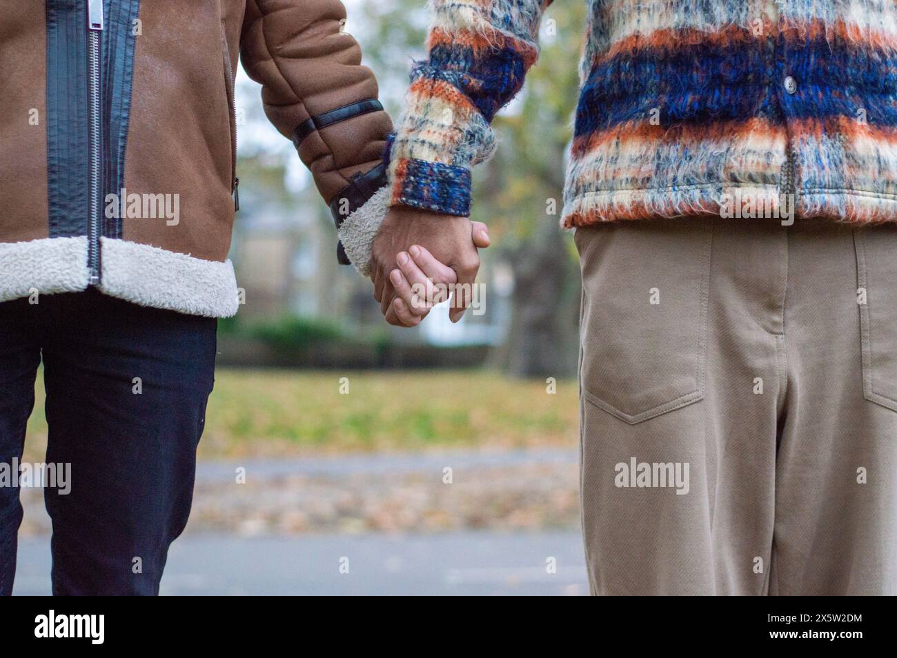 Mid adult men holding hands, close up Stock Photo - Alamy
