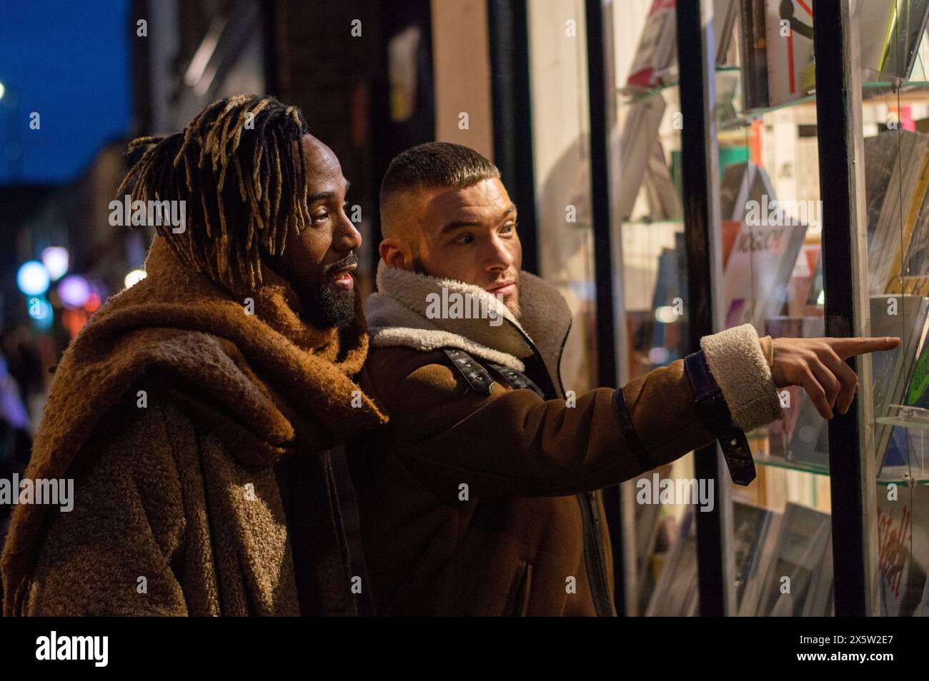 Two men looking at window display Stock Photo - Alamy