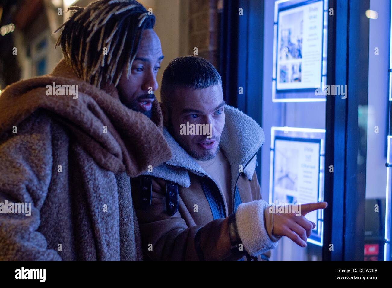 Two men looking at window display Stock Photo - Alamy