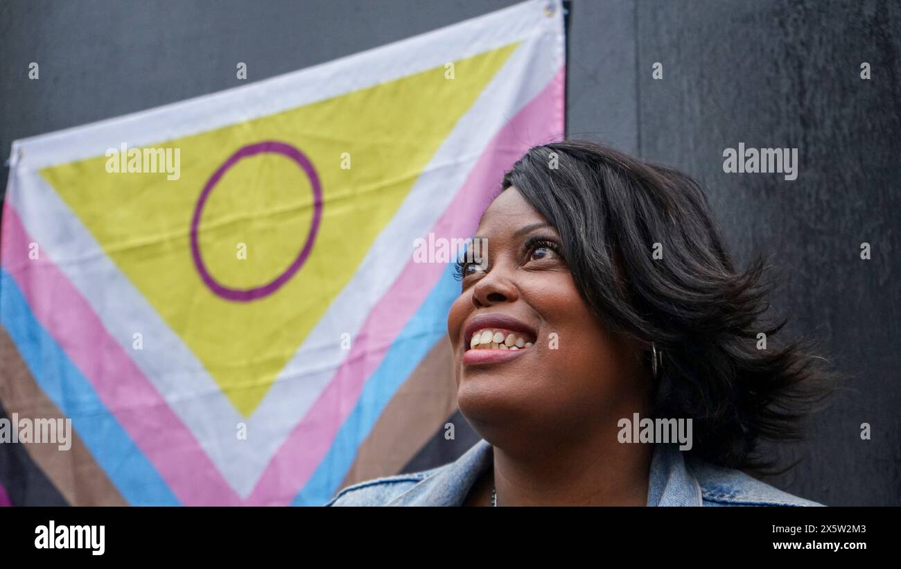 Portrait of mature woman in front of pride flag Stock Photo - Alamy