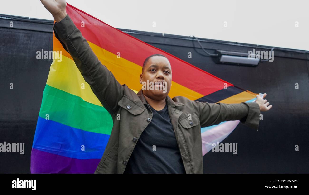 Woman holding pride flag Stock Photo - Alamy