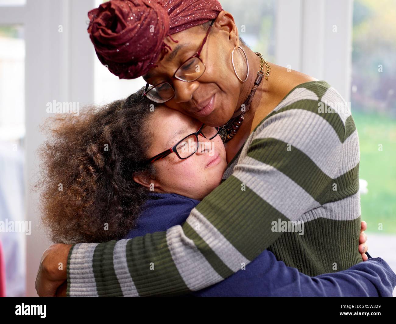 Mother and daughter with Down syndrome hugging Stock Photo - Alamy