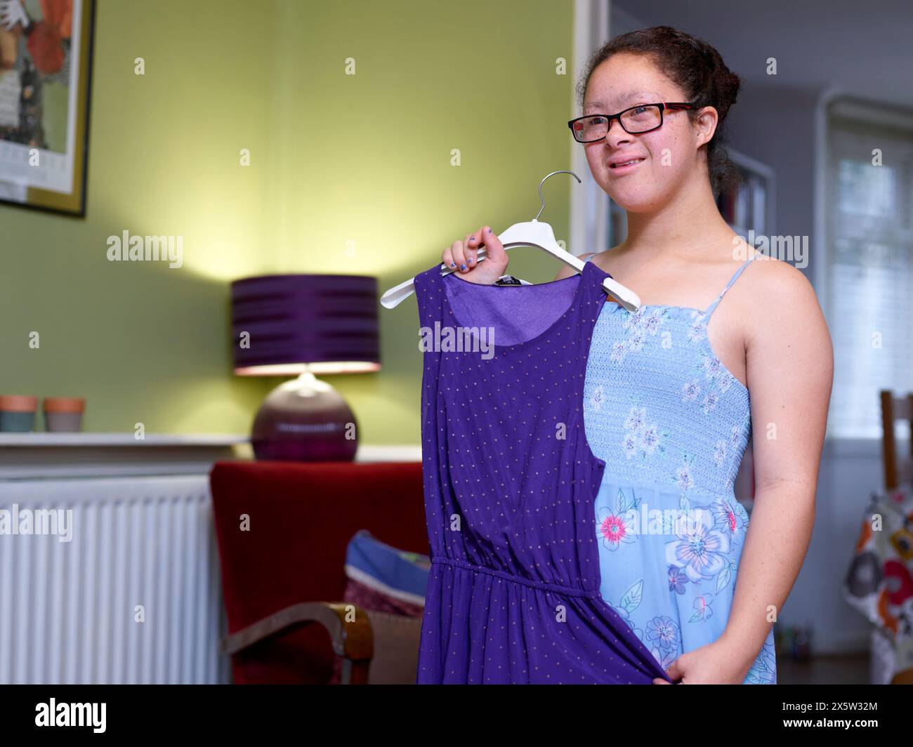 Girl with Down syndrome trying on dress Stock Photo - Alamy