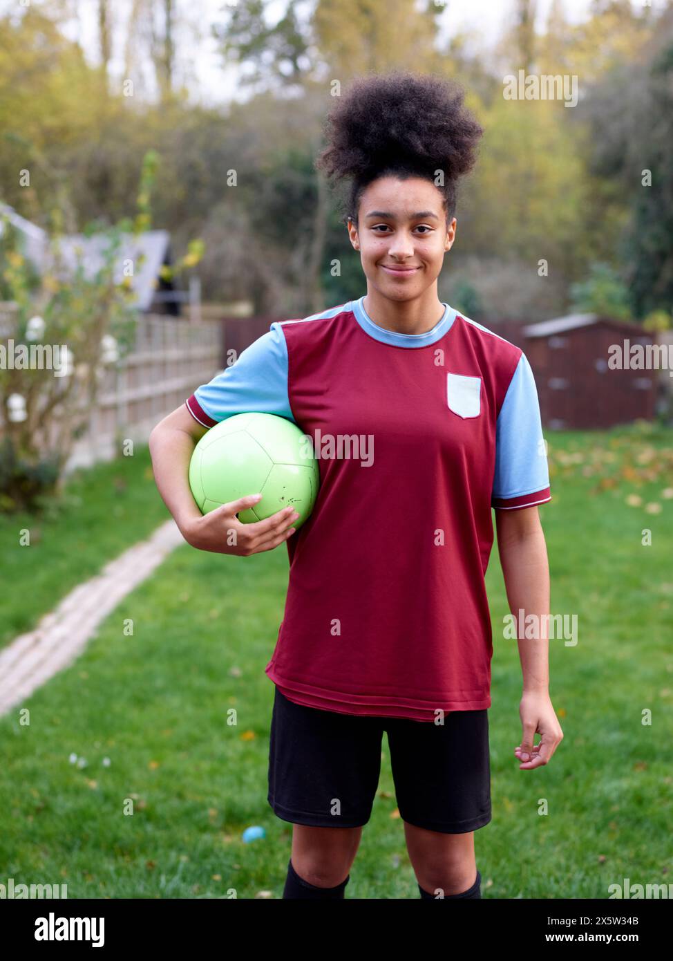 Portrait of smiling girl in soccer uniform Stock Photo - Alamy