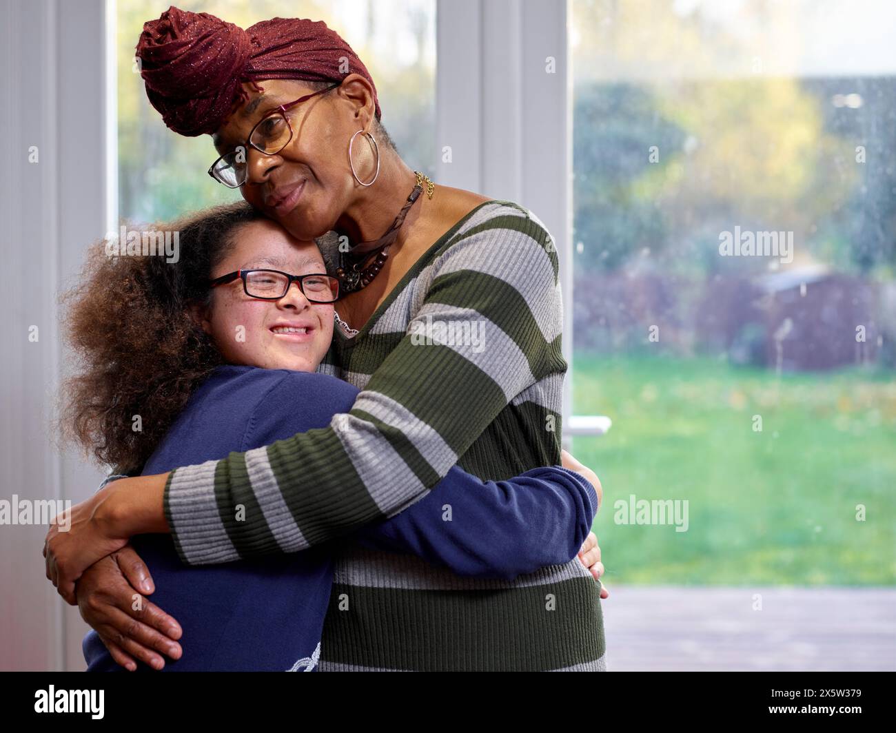 Mother hugging daughter with Down Syndrome Stock Photo - Alamy