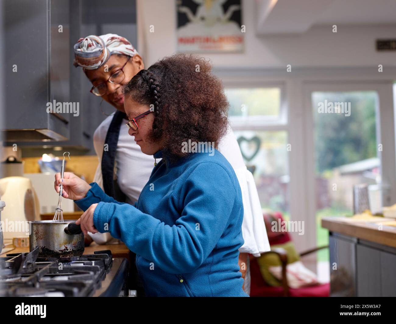 Mother with daughter (16-17) with Down Syndrome cooking together Stock ...
