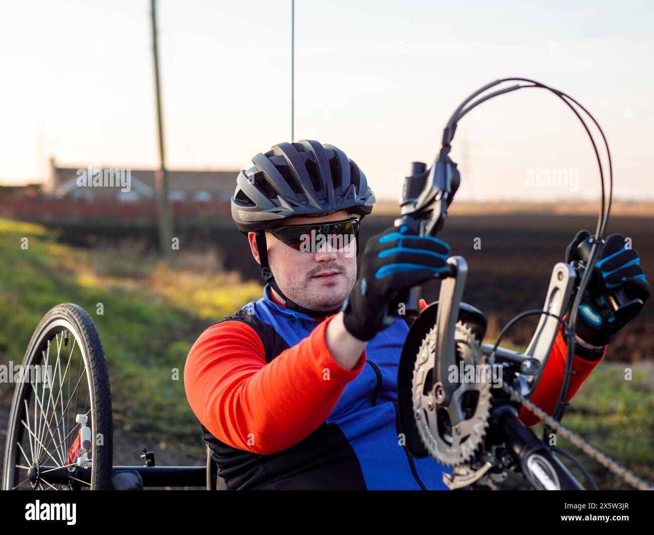 Disabled man on handcycle on roadside Stock Photo - Alamy