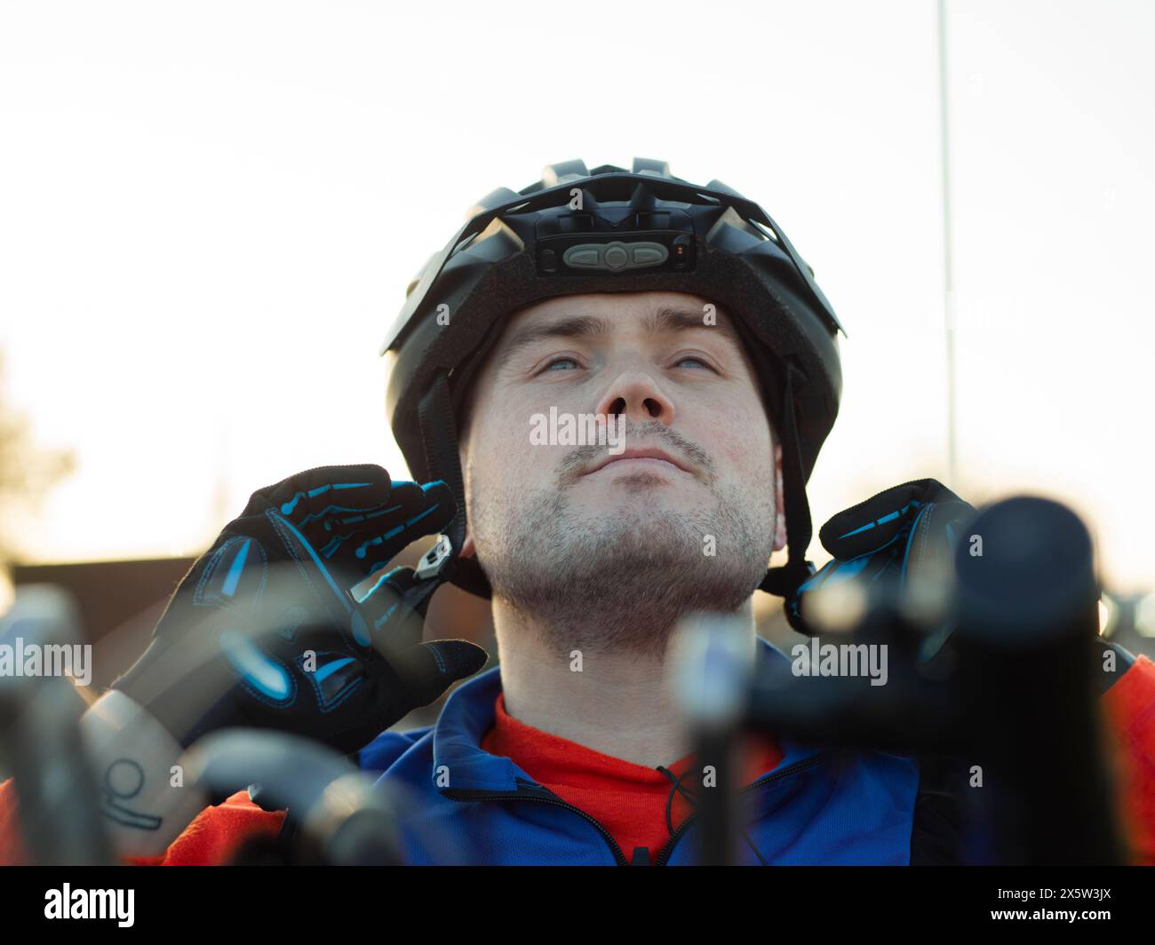 Disabled man on handcycle putting on cycling helmet Stock Photo - Alamy