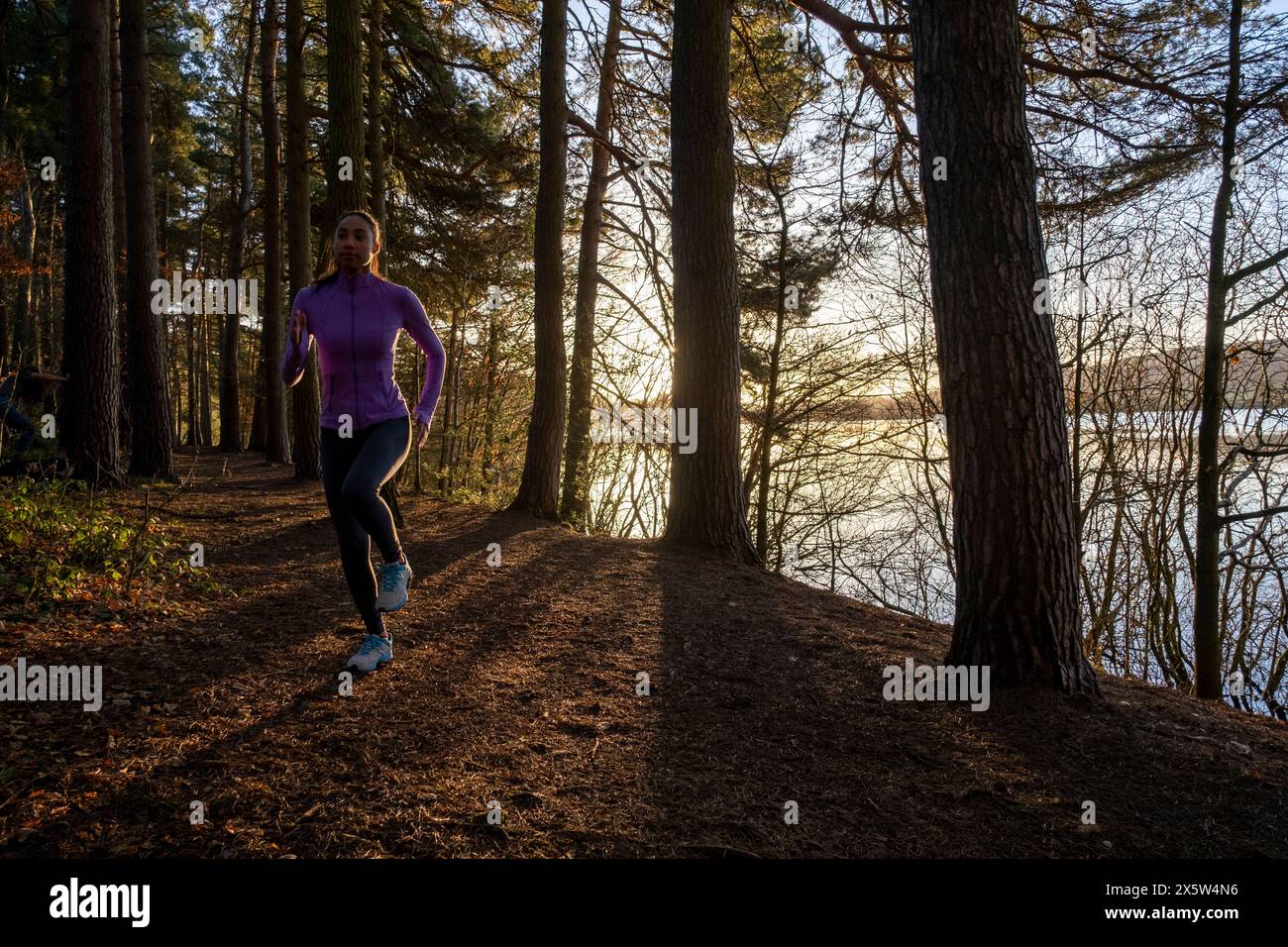 Woman jogging in the forest hi-res stock photography and images - Alamy